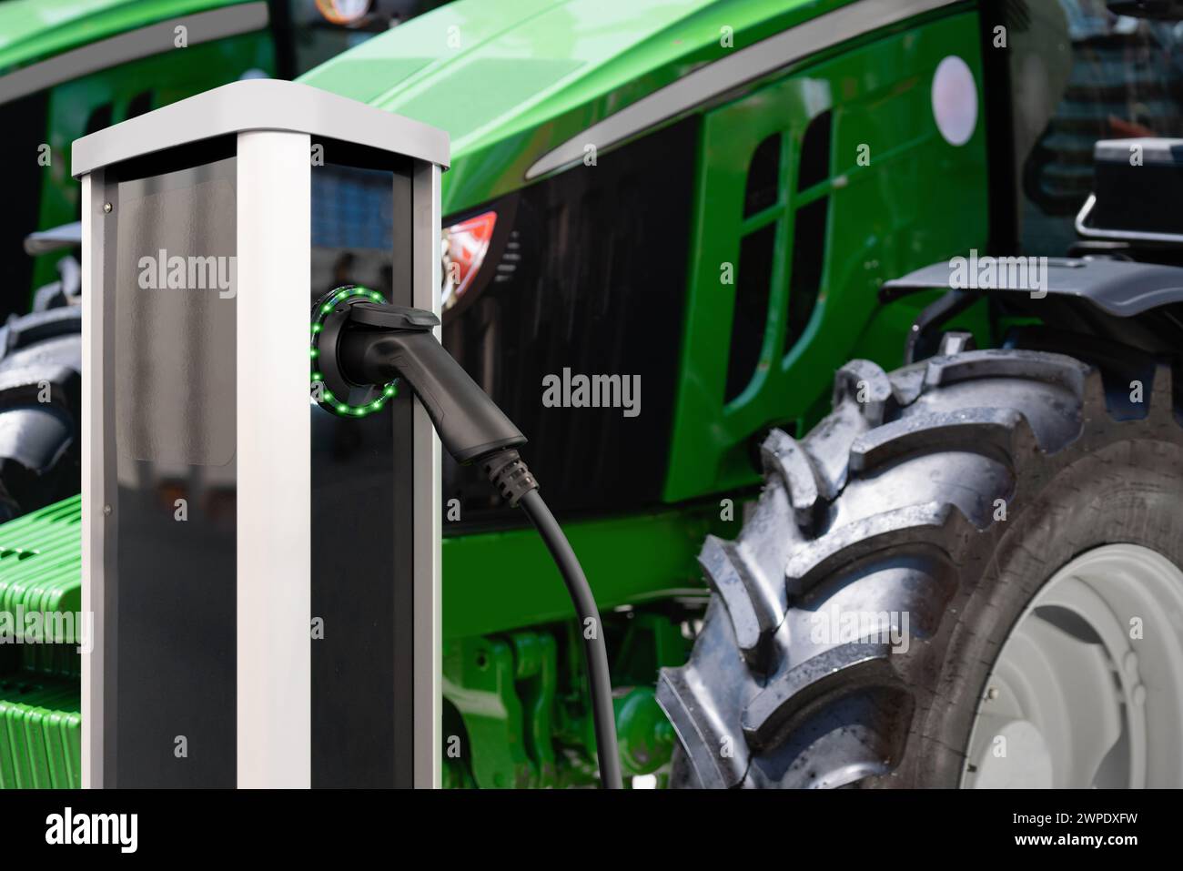 Electric vehicles charging station on a background of agricultural ...