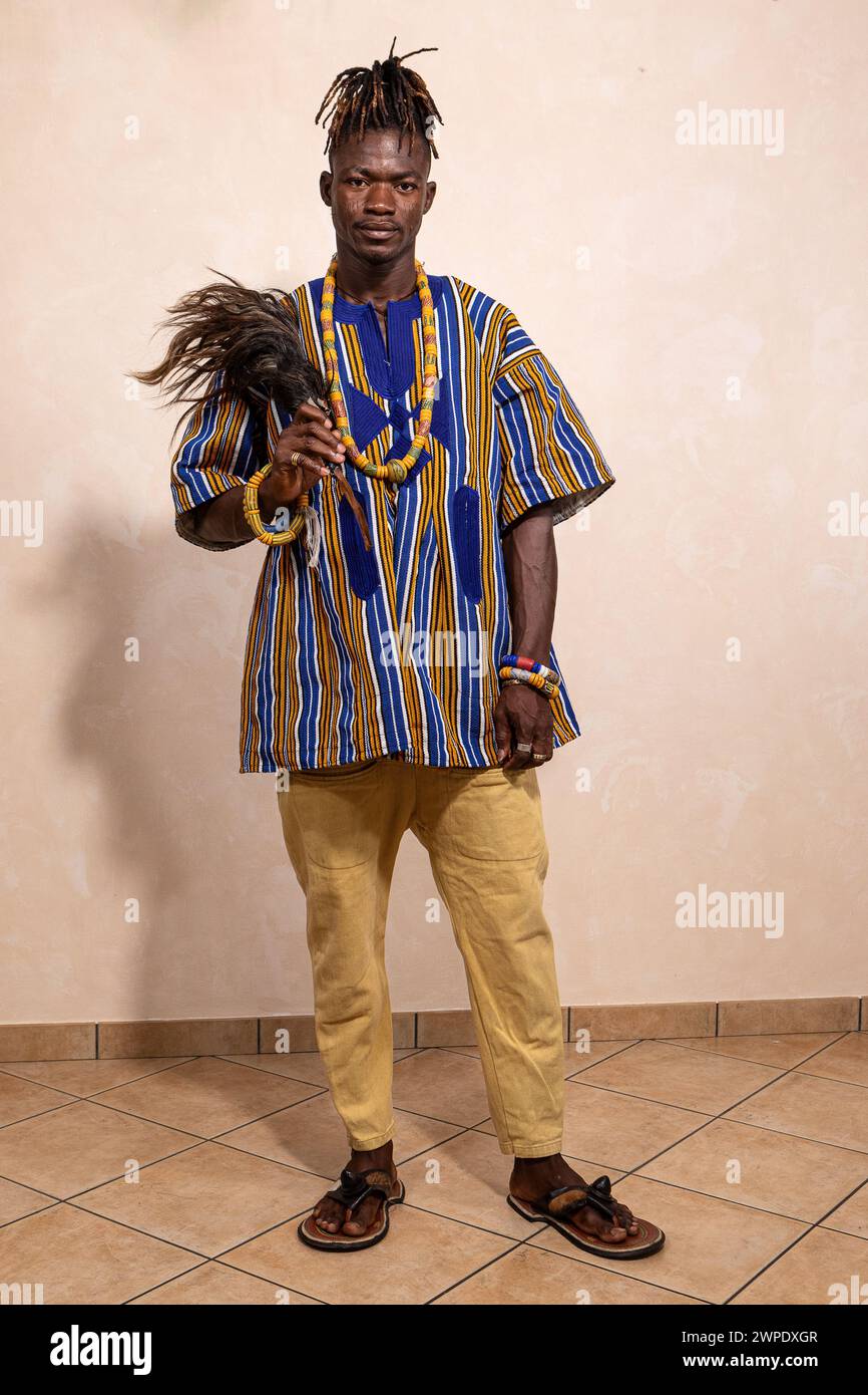 Proud African man showcasing vibrant traditional attire with a ...