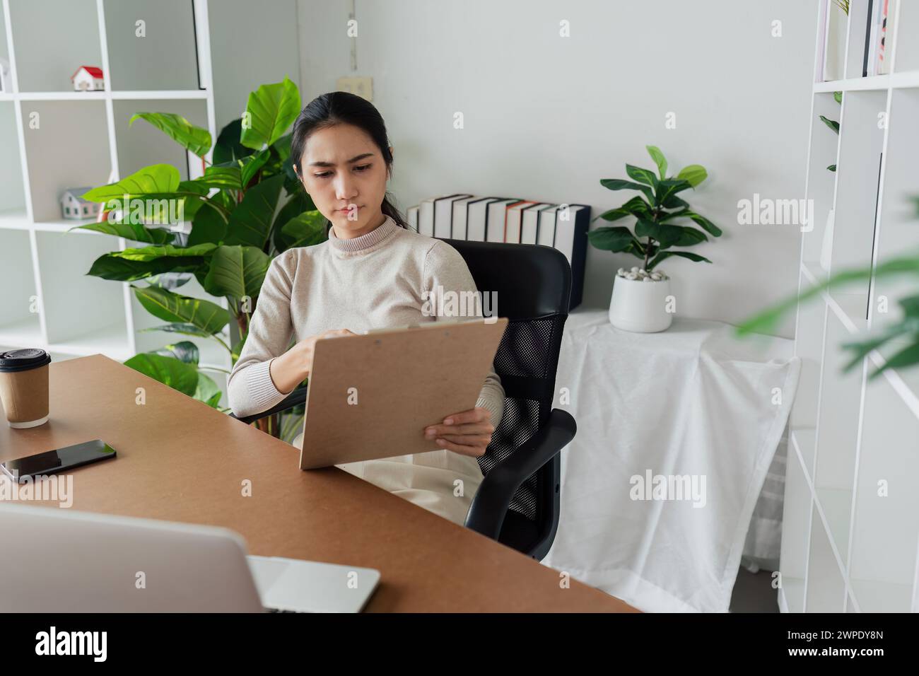 Woman surrounded by paperwork hi-res stock photography and images - Alamy
