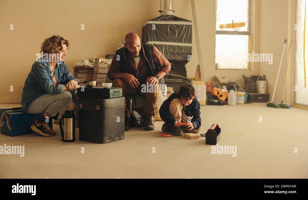 Parents on a home renovation project take a coffee break while their ...