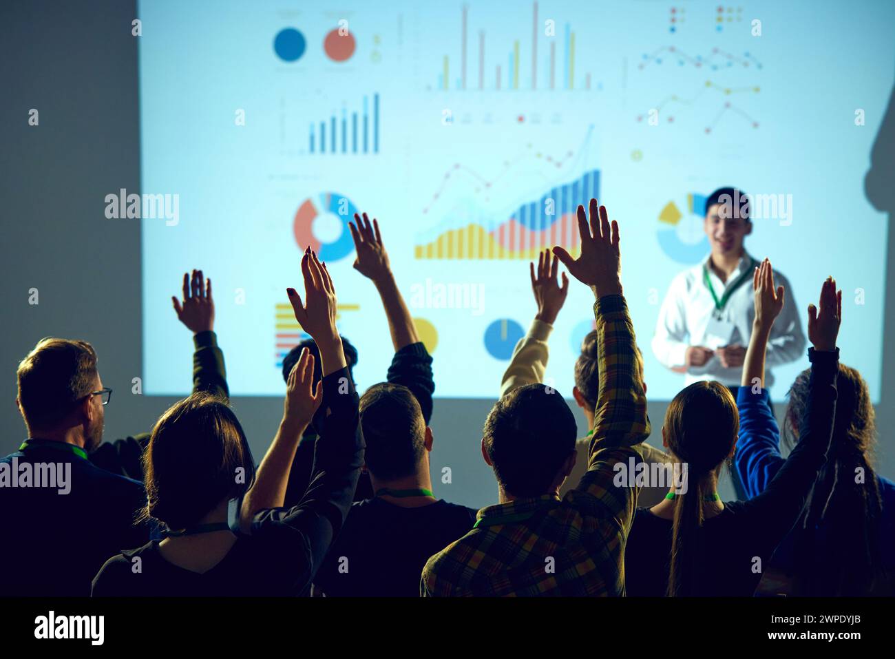 Interactive business workshop with participants engaging with presenter ...