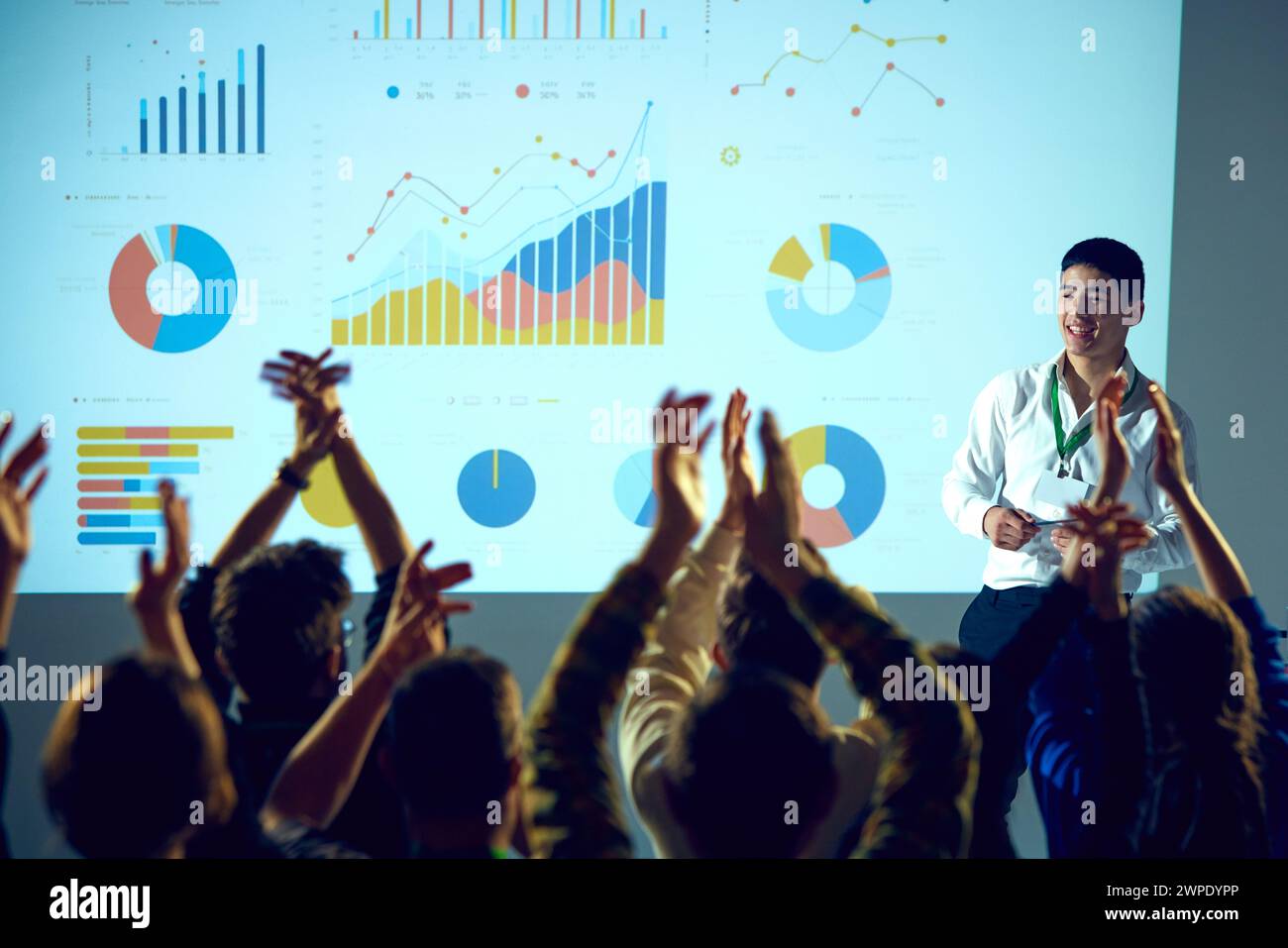 Business training session surrounded by data visualizations where man ...