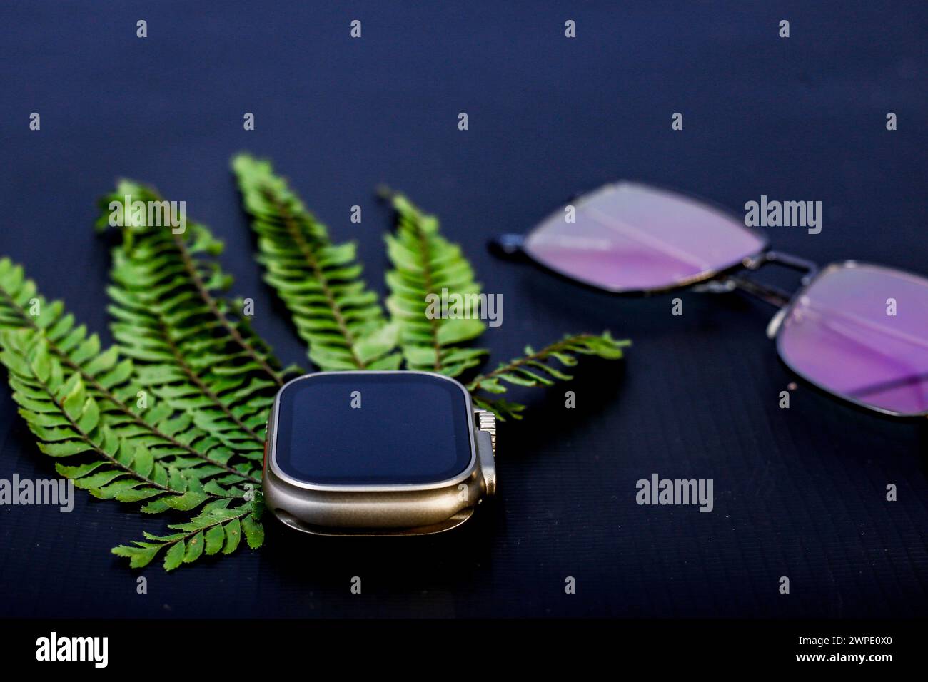said view on Stylish smart watch and sun glass. in black background ...
