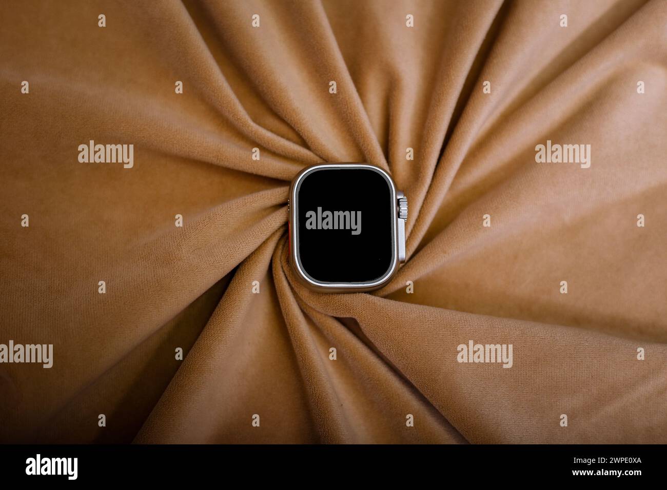 Top view Stylish smart watch covered by Brown color Cloth Stock Photo ...