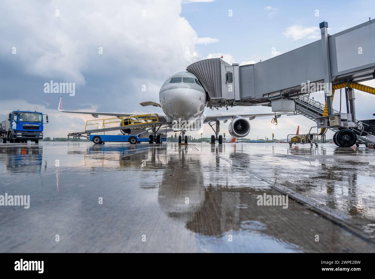 Airplane at the airport. Passengers board through a telescopic gangway ...