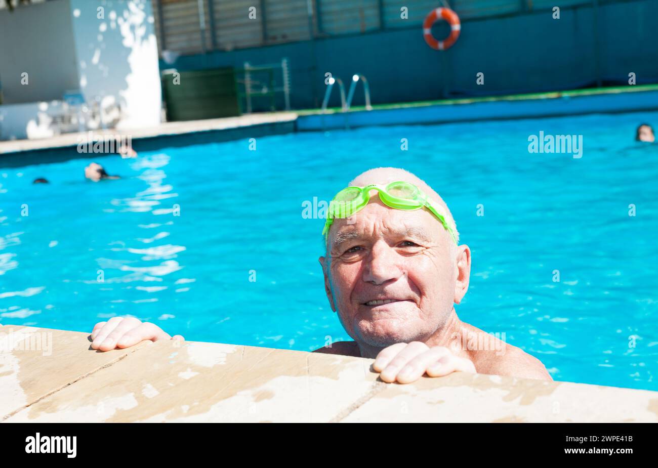 Happy old man posing in swimming pool Stock Photo - Alamy