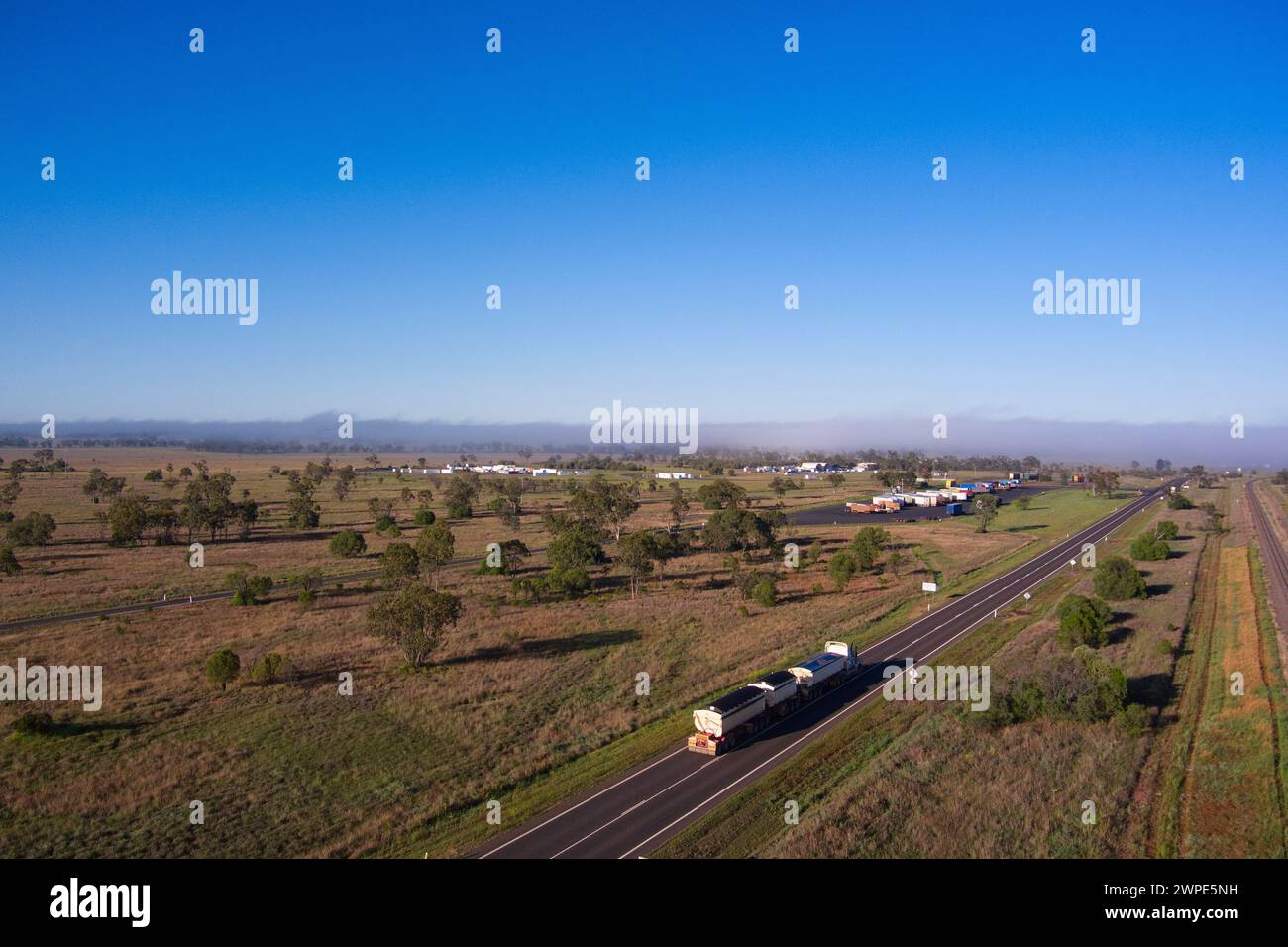Aerial of road train heading west on the Warrego Highway near Roma ...