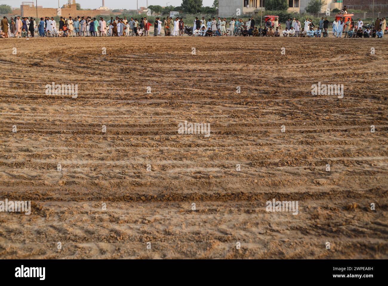 ploughing with tractor in kabaddi ground. The tractor driver plays the ...