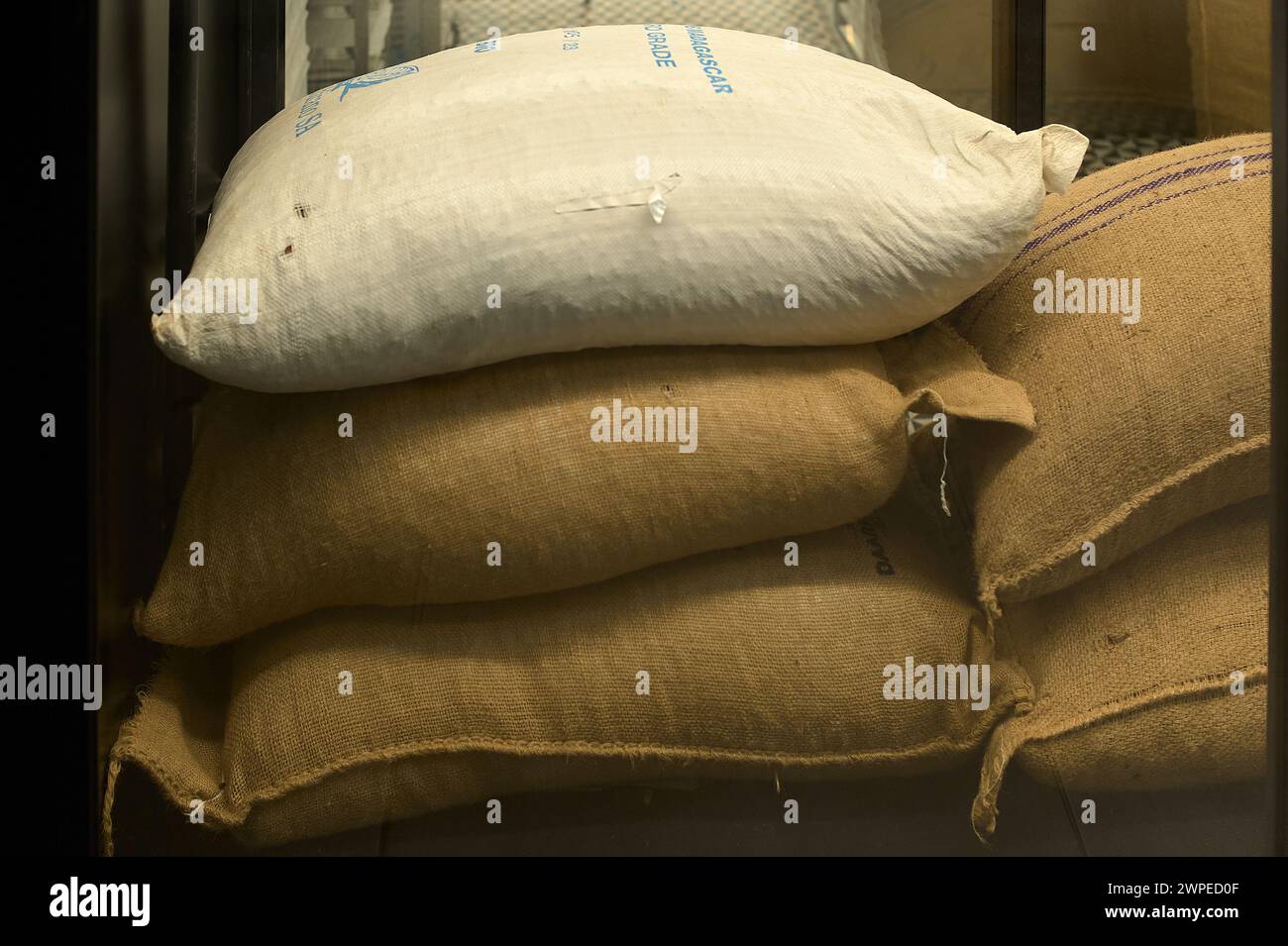 Stacked sacks, some jute and one white, in a dark space Stock Photo - Alamy