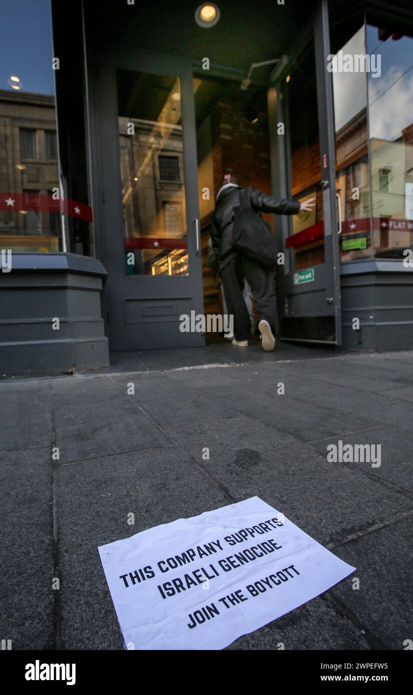 A protester leaves a sign saying 'This Company Supports Israeli ...