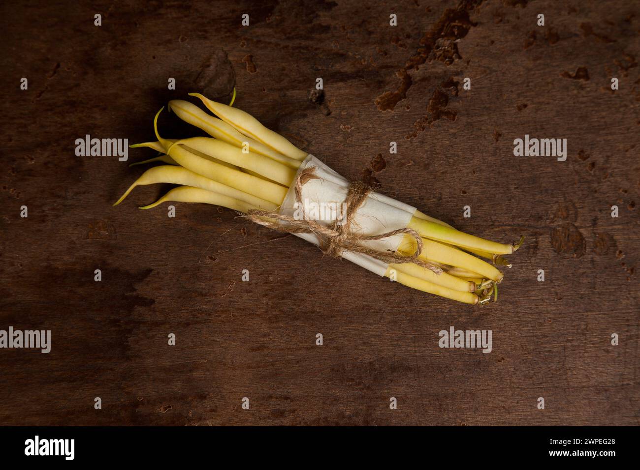Bunch of raw yellow pods of haricot on wooden background. French beans ...