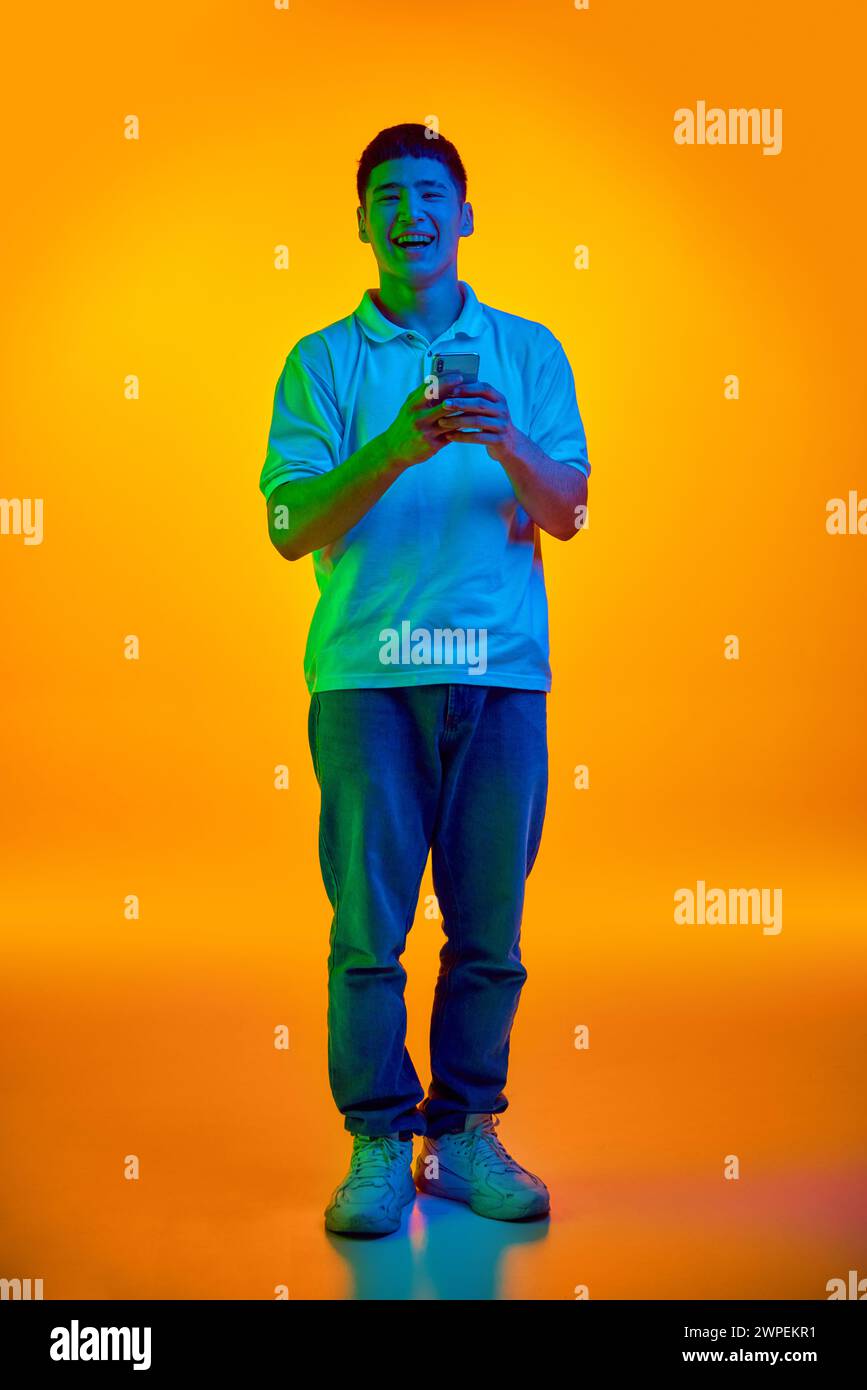 Full-length portrait of smiling Asian man dressed casual outfit ...