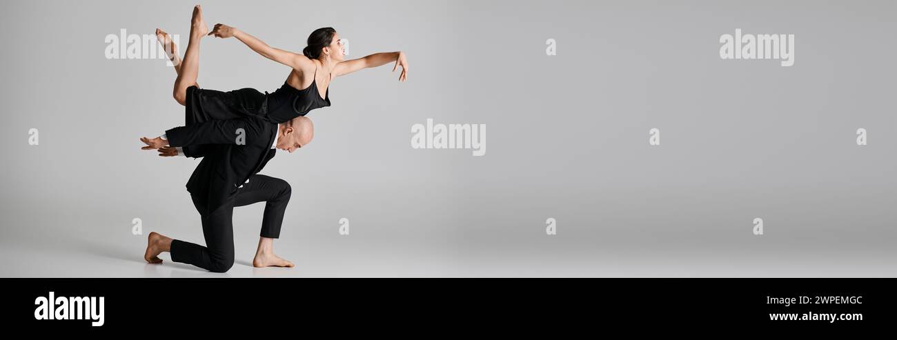 Graceful dance, young couple performing an acrobatic routine in studio ...