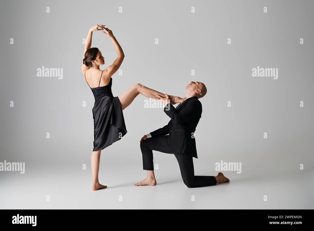 Graceful dance of young couple performing together in studio setting ...