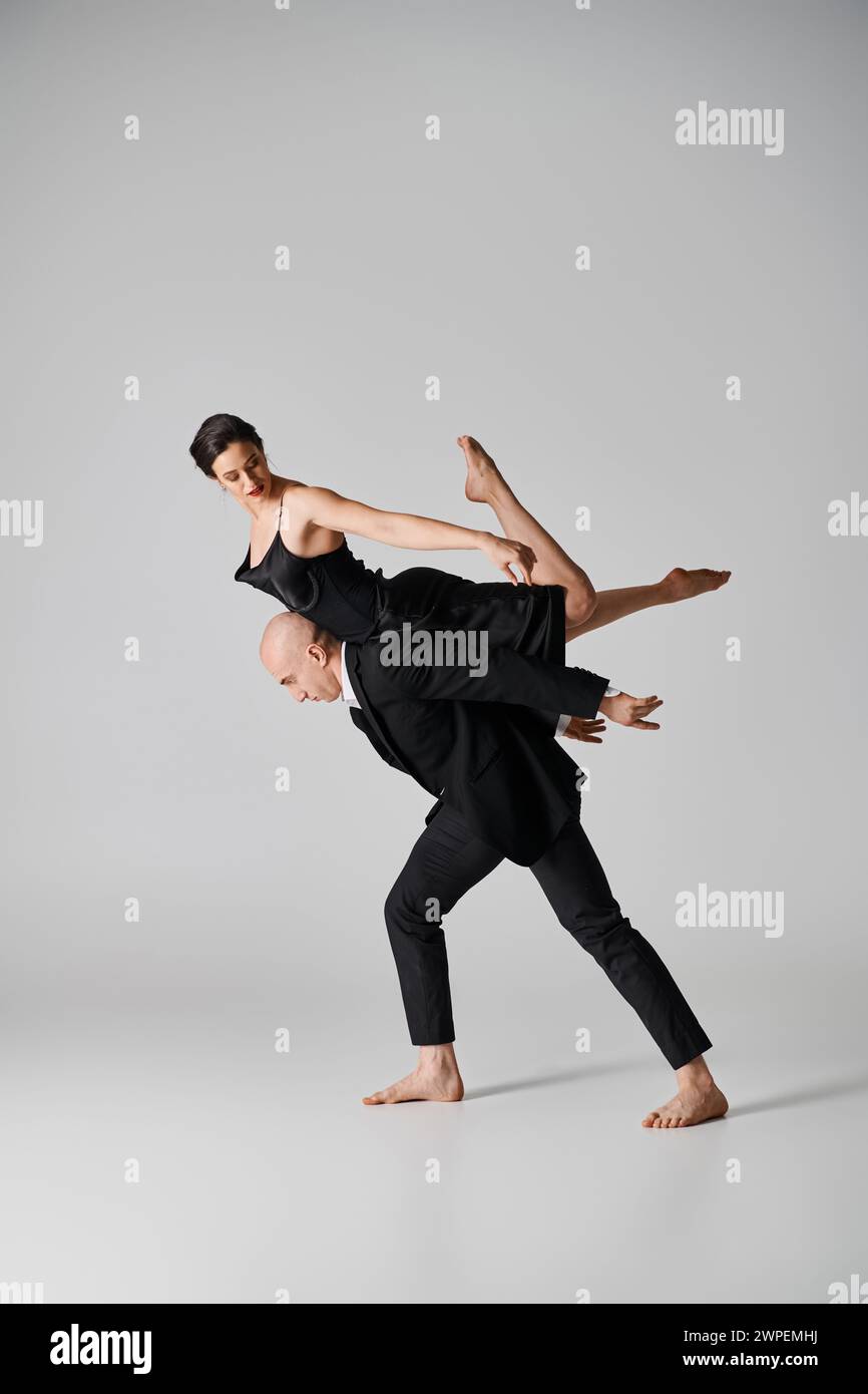 Graceful dance, young couple performing an acrobatic routine in a ...