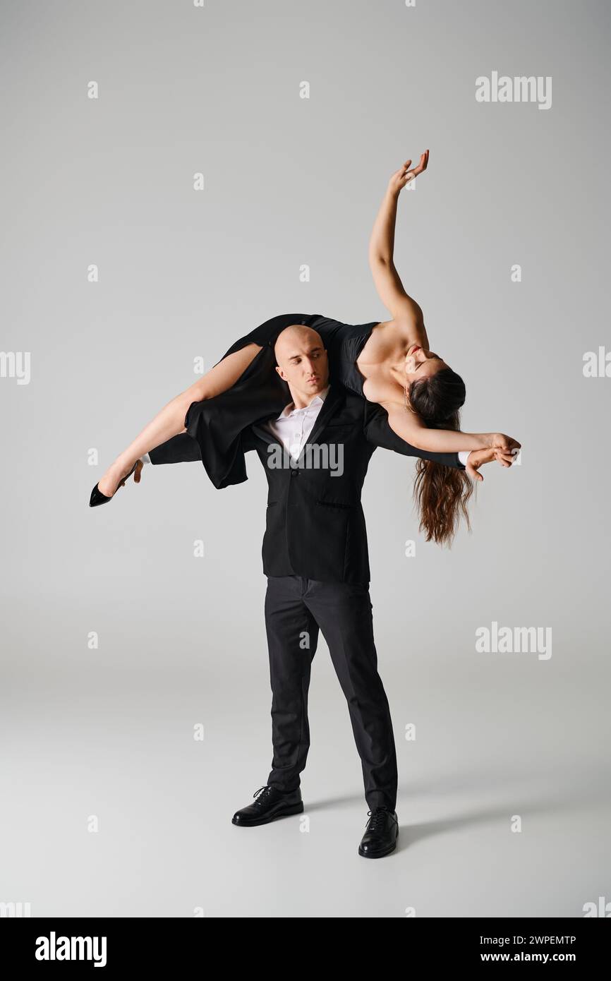 strong male dancer lifting brunette woman in dress and high heels in ...