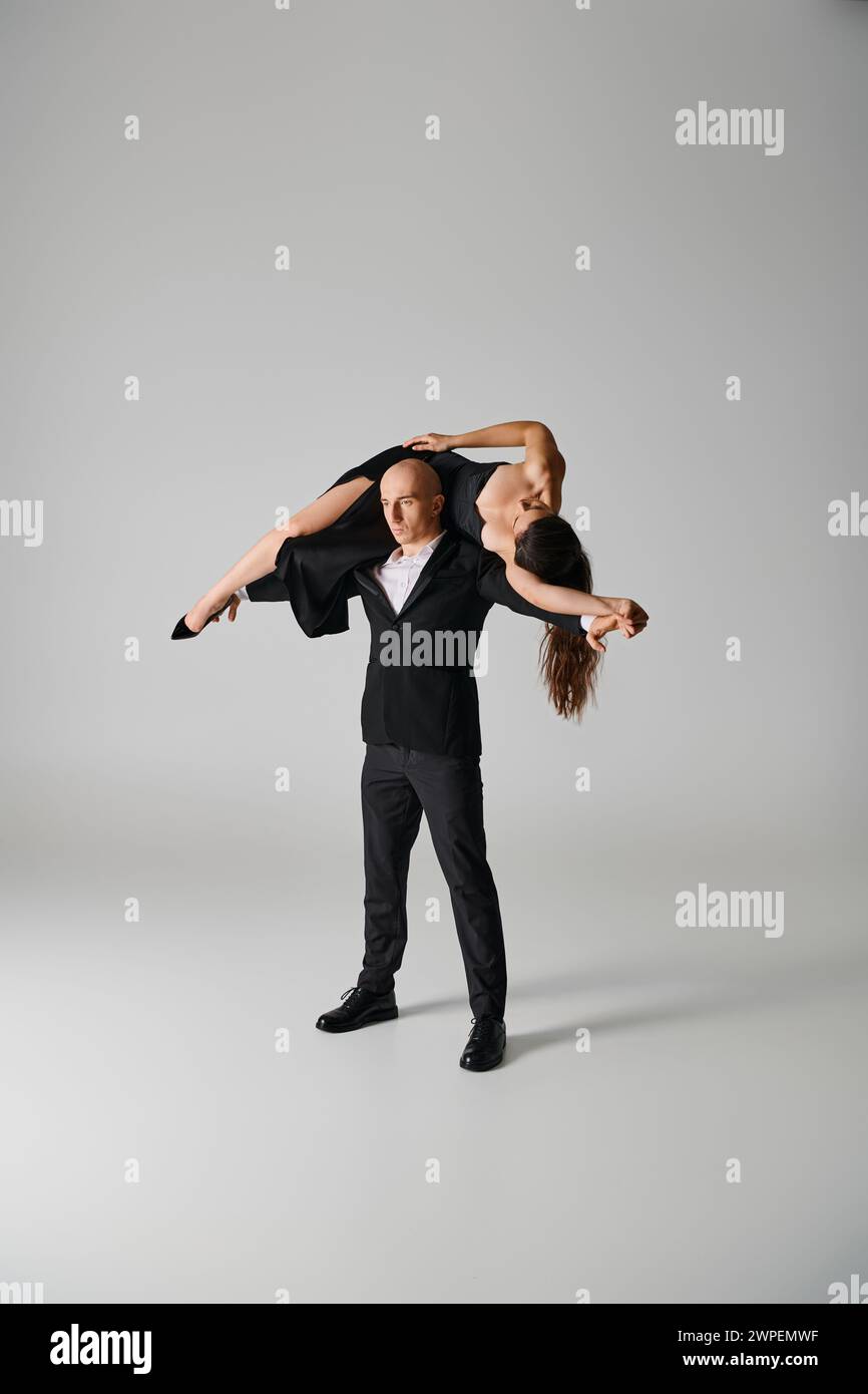 strong male dancer lifting brunette woman in dress and high heels on ...