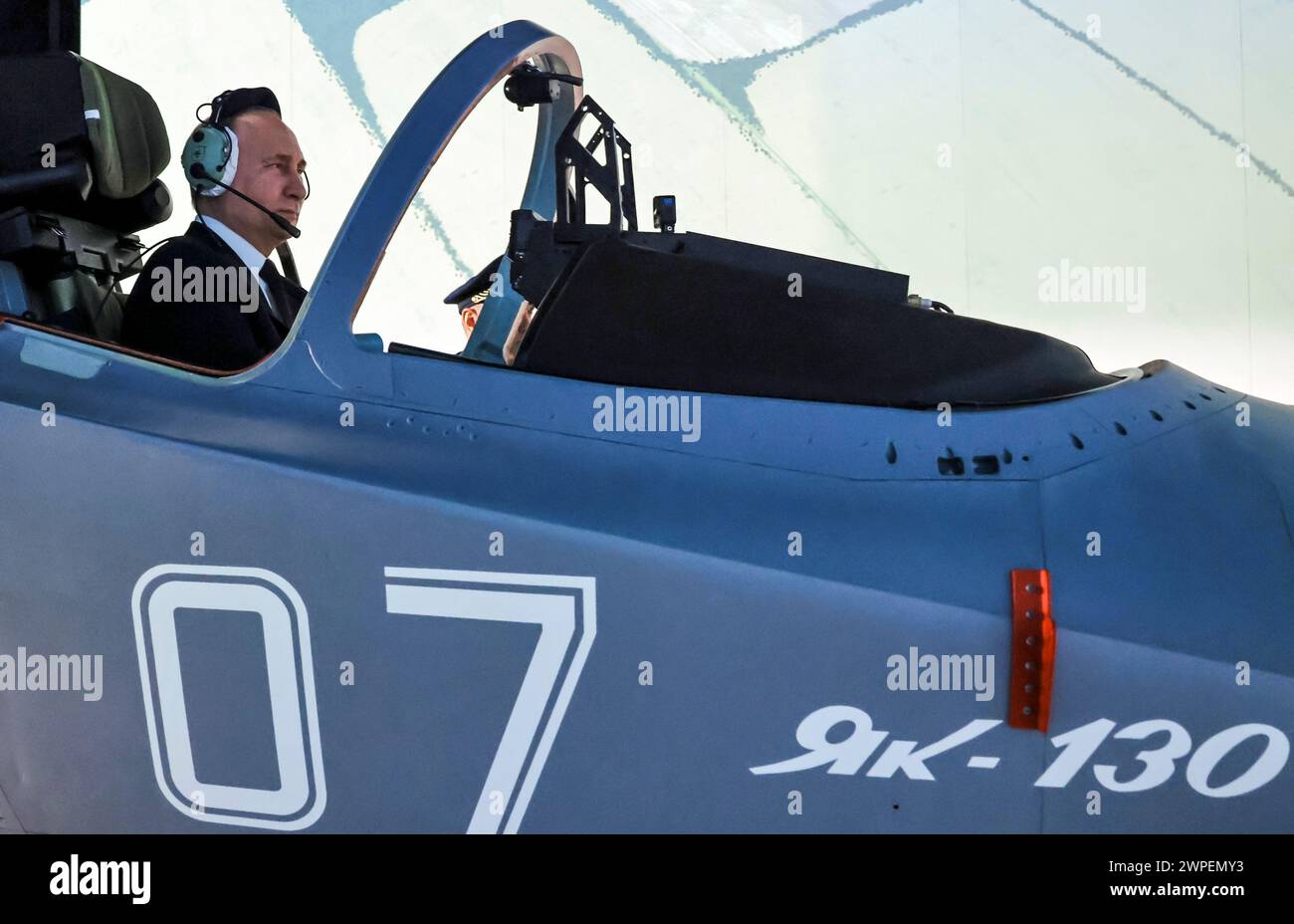 Russian President Vladimir Putin sits in a cockpit of a flight ...