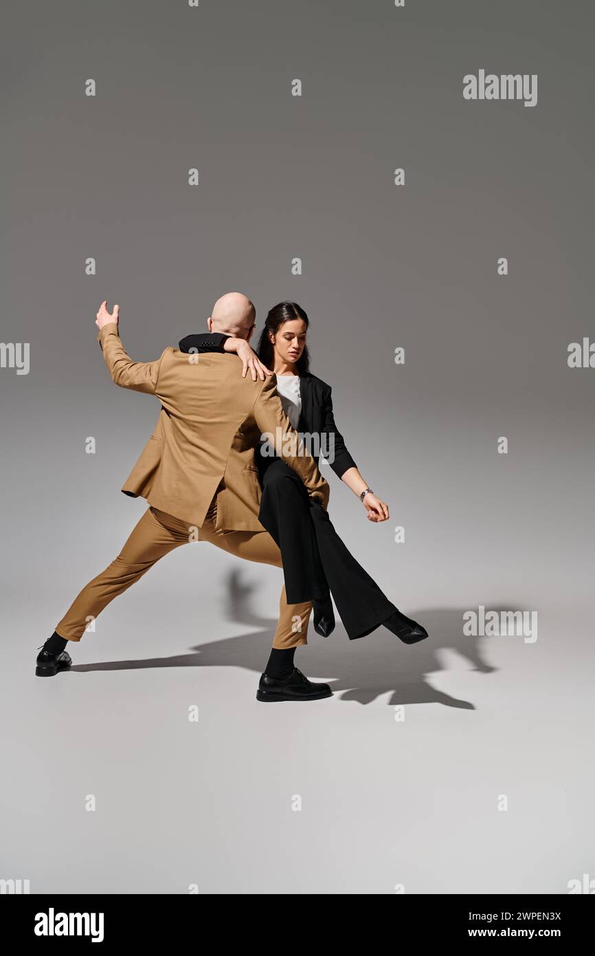 Businesspeople in suits perform a dynamic dance move in the studio with ...