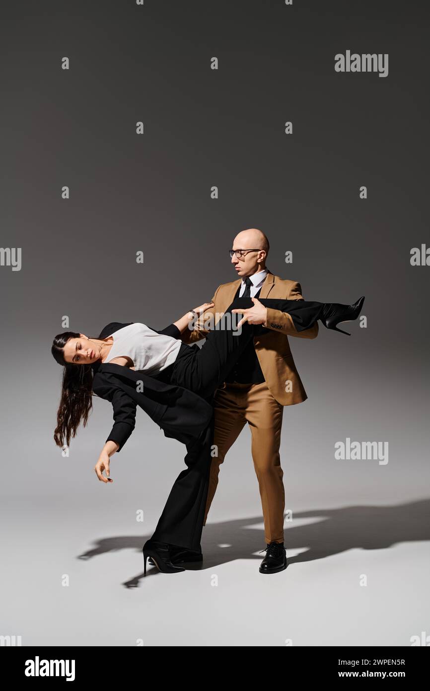 man in glasses and suit supporting leg of brunette woman in high heels ...