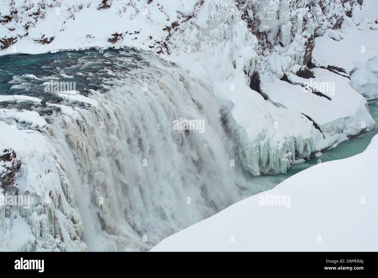 Majestic frozen waterfall with icy cliffs and snow-covered rocks ...
