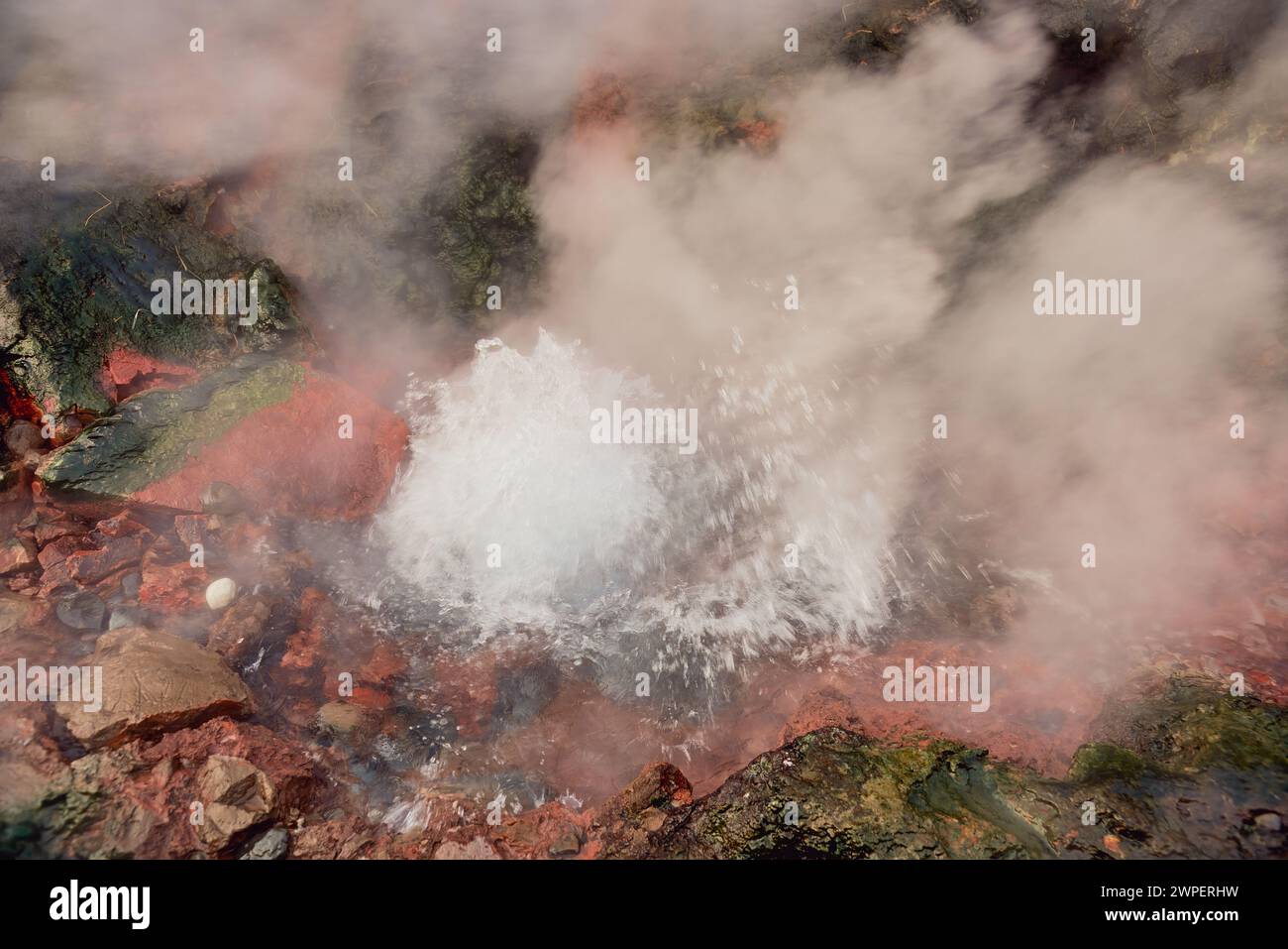 Vibrant geothermal spring with steam and colorful mineral deposits ...