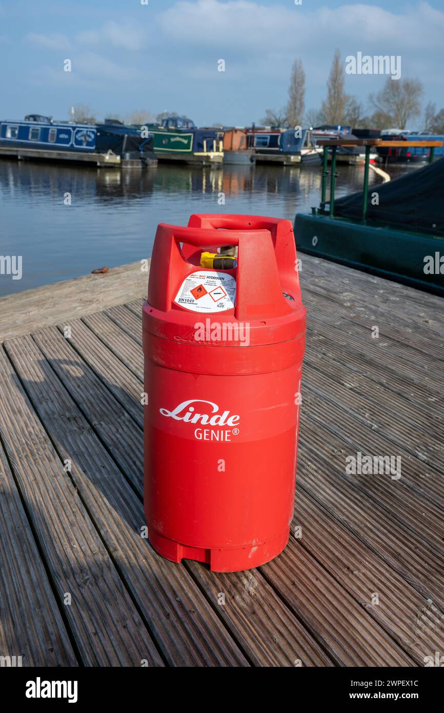 Red lightweight GENIE hydrogen gas cylinder seen on a deck close to a ...