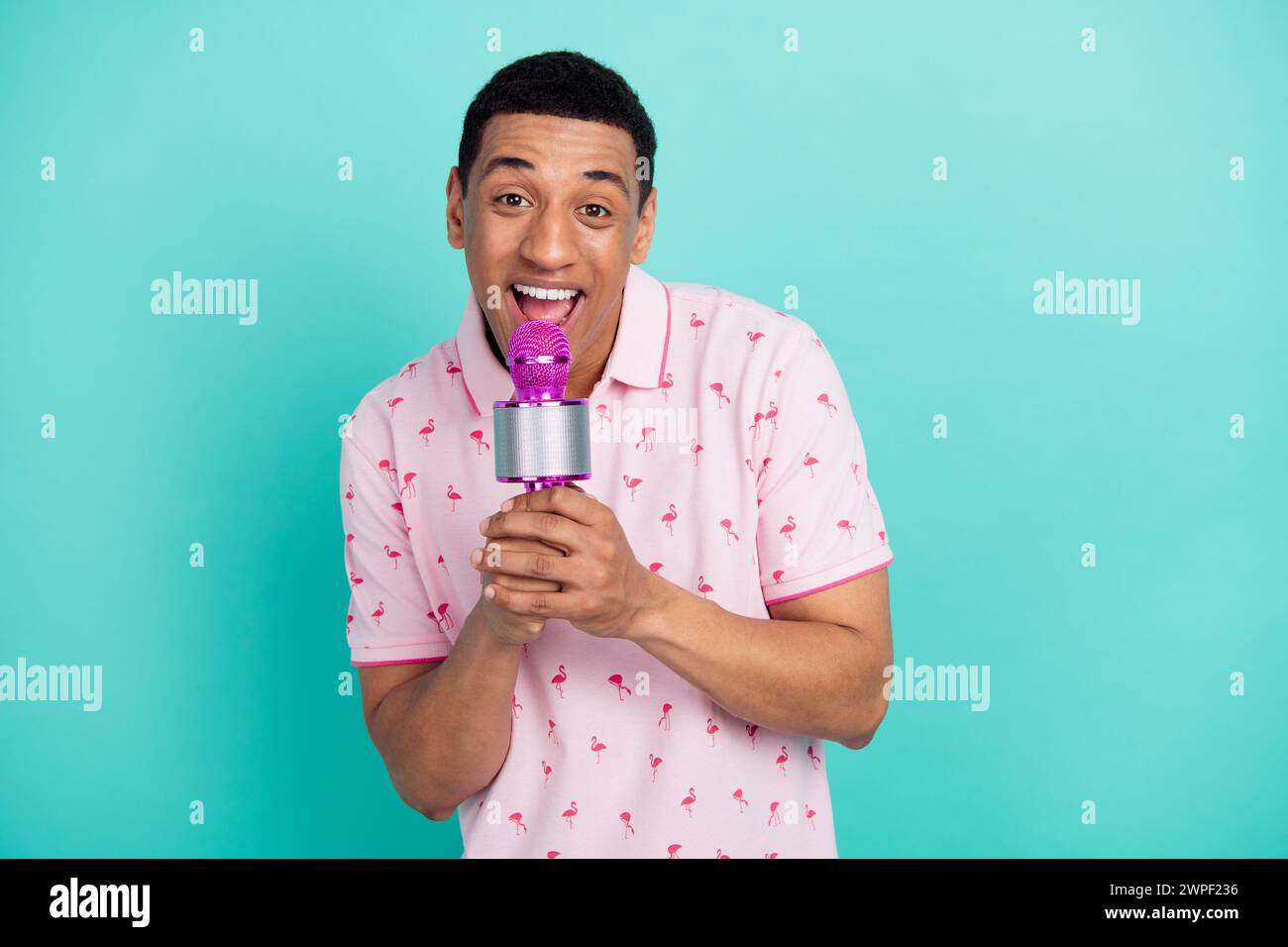 Portrait of positive overjoyed man have good mood sing microphone empty ...
