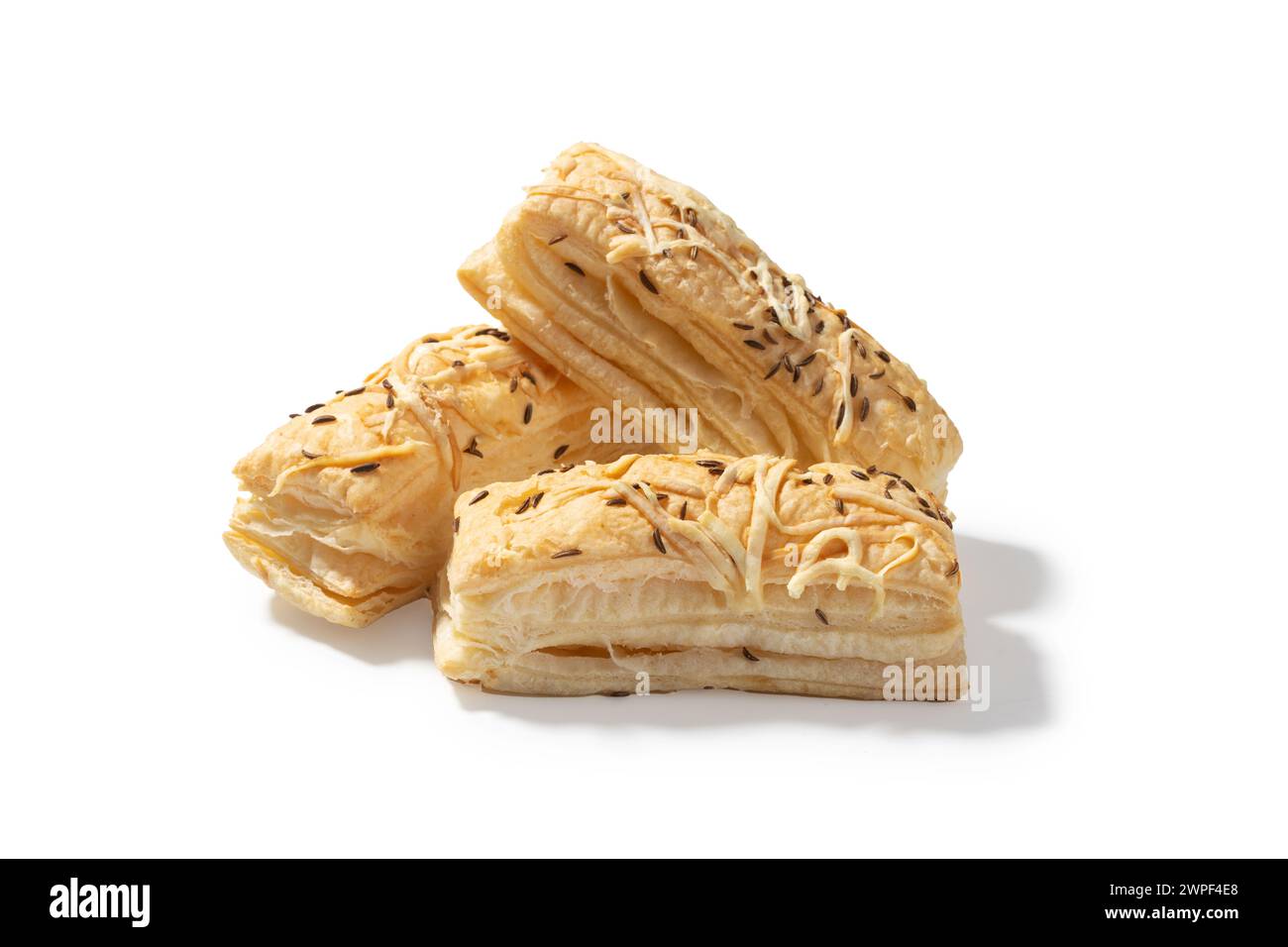 Three delectable cheese crackers, each adorned with a savory blend of ...