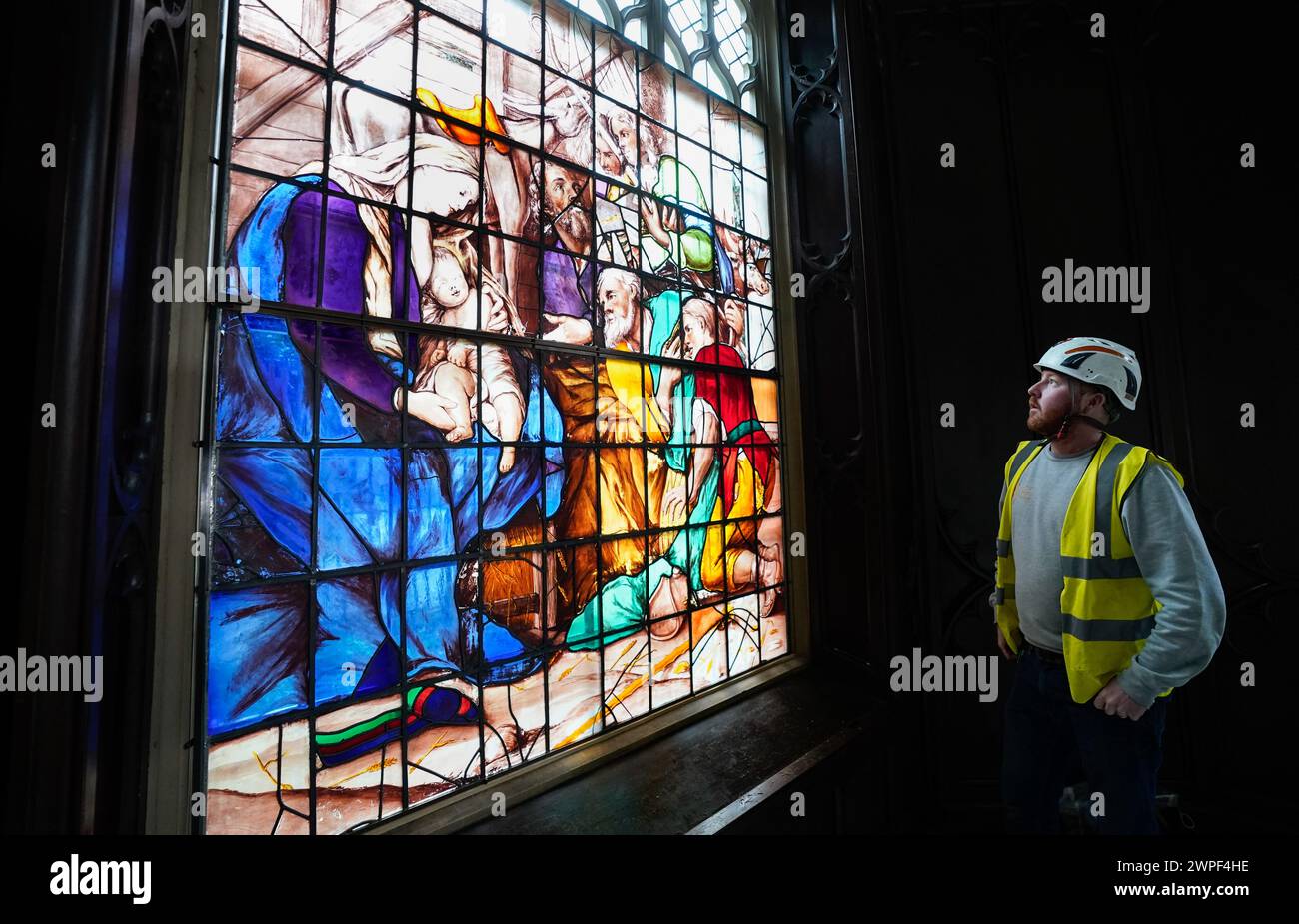 Director of Holy Well Glass, Jack Clare, inspects a newly conserved ...