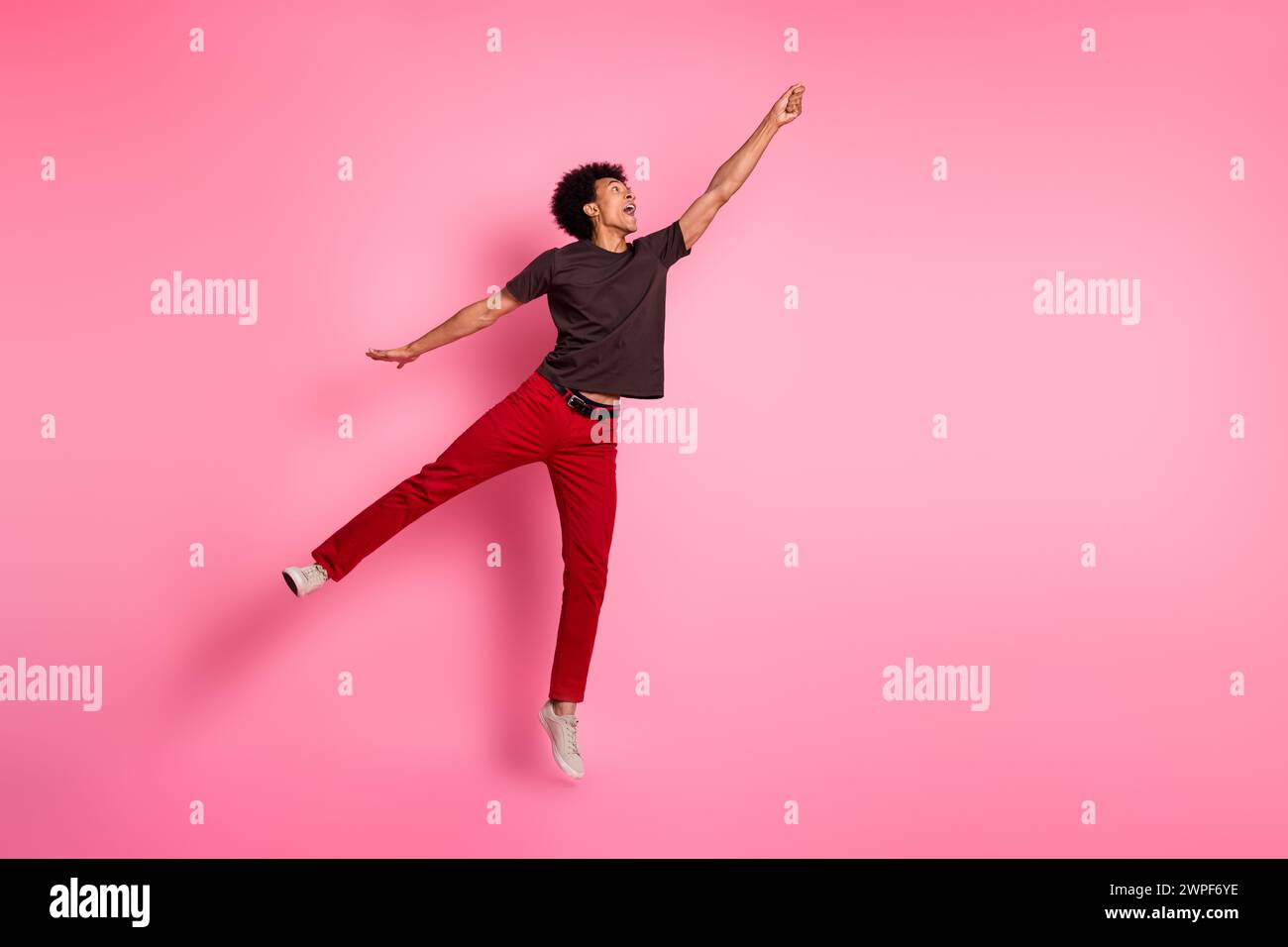 Full length size photo of young funny guy jumping trying to catch his ...