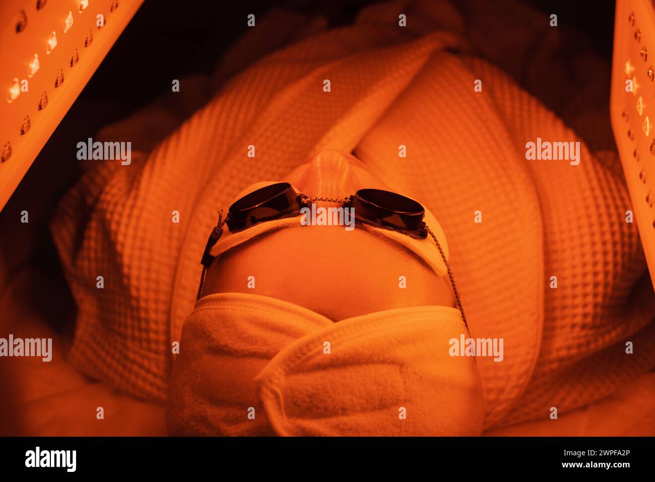An elderly woman undergoes a facial rejuvenation procedure. Woman face ...