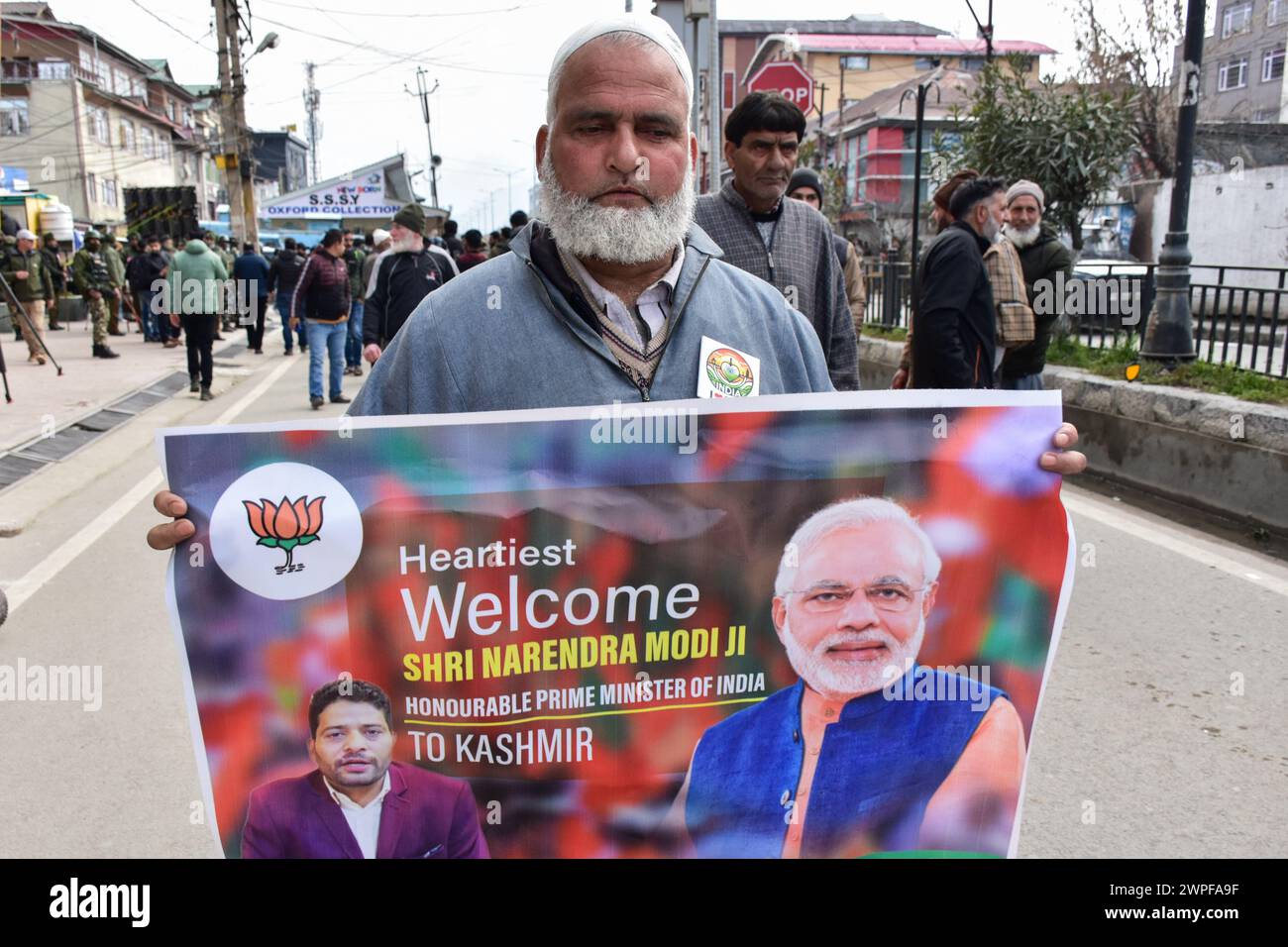 A supporter of Bharatiya Janta Party (BJP) holds a banner outside a ...