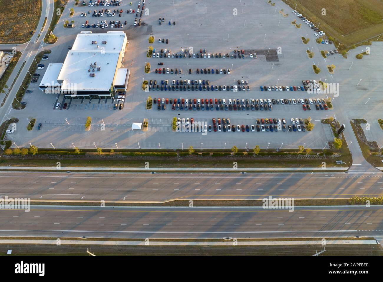 Aerial view of dealership parking lot with many brand new cars for sale ...