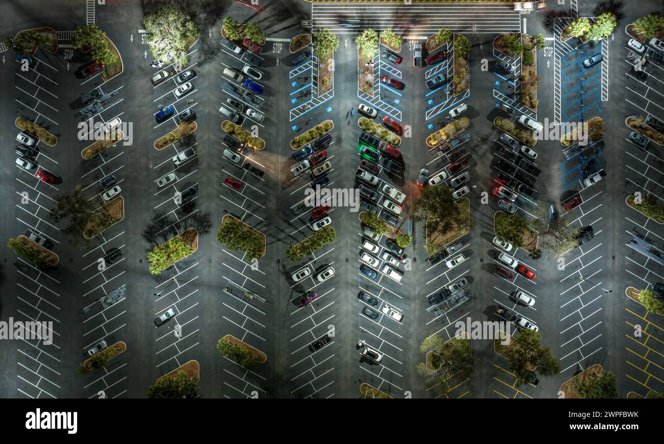 Aerial view of many cars parked on parking lot with lines and markings ...