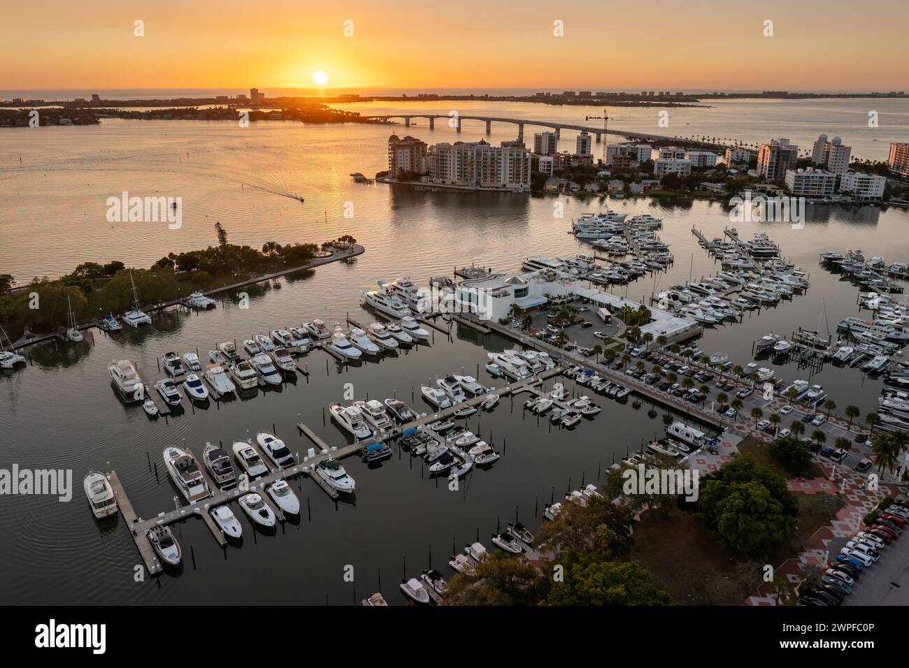 Aerial view of Sarasota city downtown at sunset with bay marina yachts ...