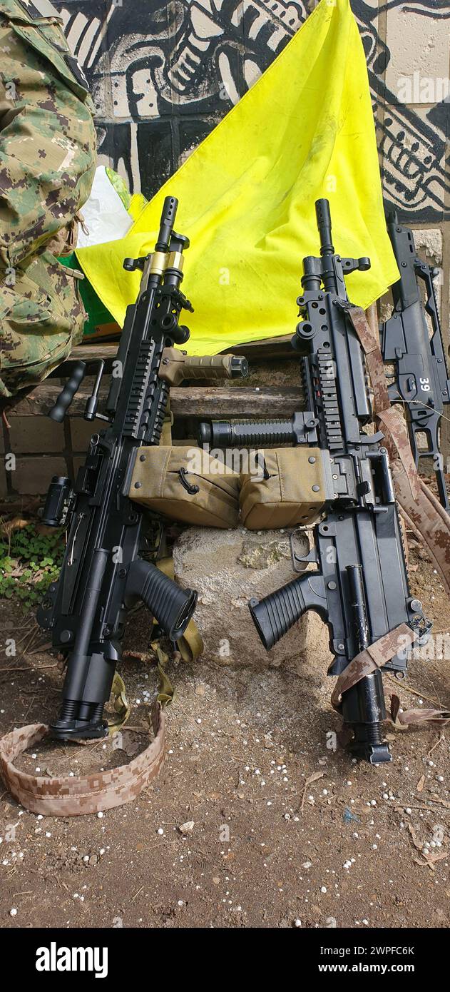 two machine guns against the background of a yellow flag and an old ...