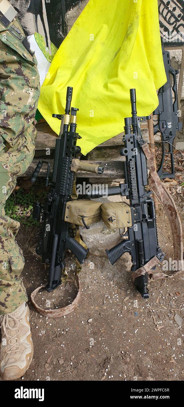 two machine guns against the background of a yellow flag and an old ...