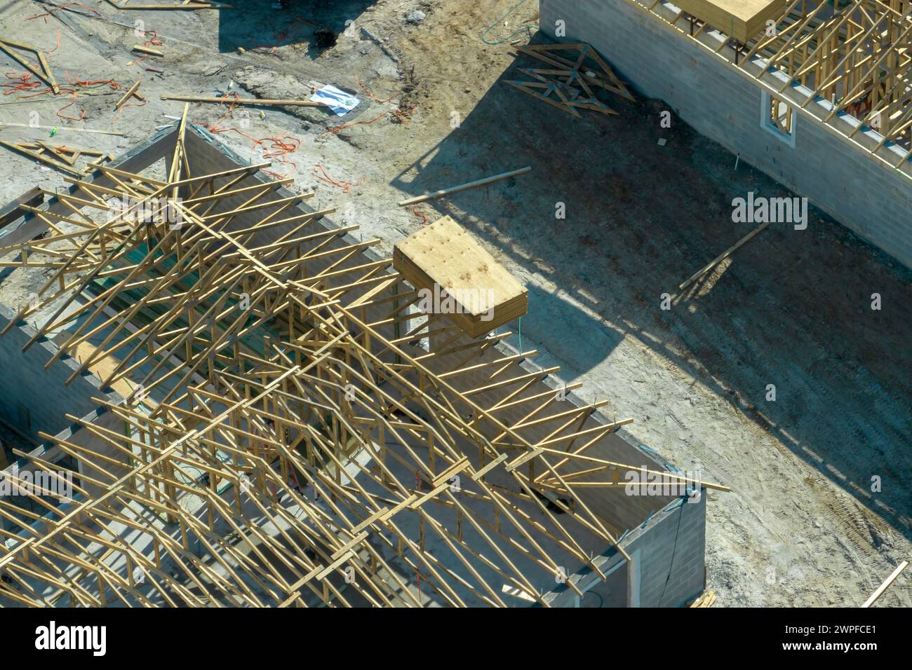 Builders working on roof construction of unfinished residential house ...