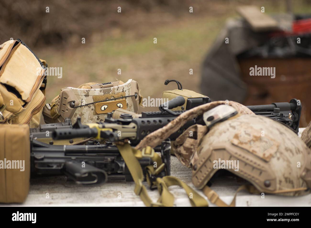 airsoft replica weapon and top camouflage helmet AOR 1, machine gun on ...