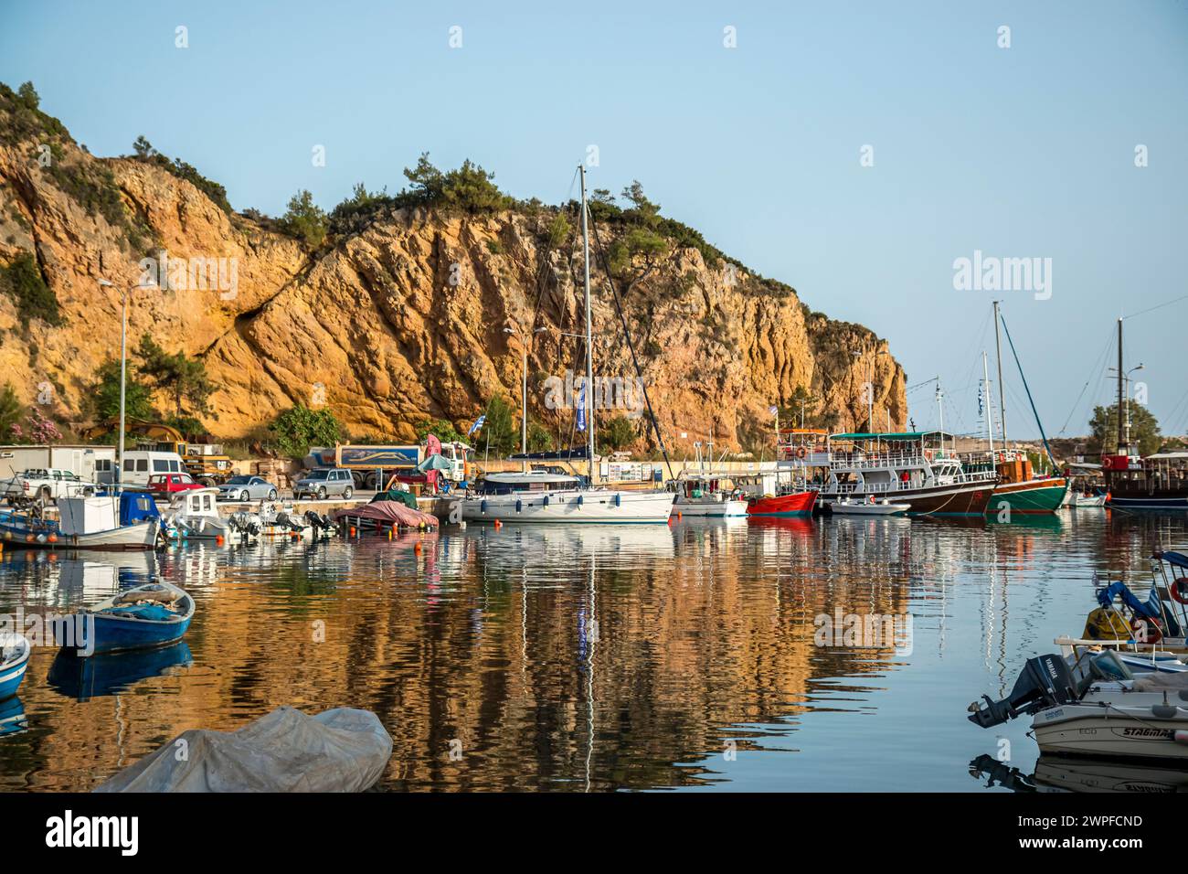Small boats and yachts docked on the marina park with oceanfront view ...