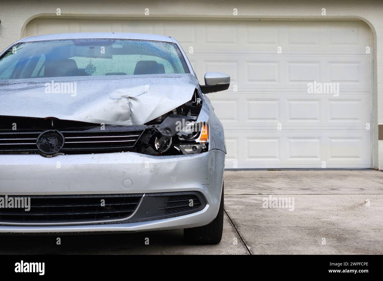 Damaged car after traffic accident parked on private home driveway ...