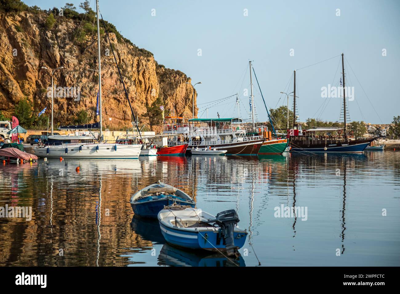 Small boats and yachts docked on the marina park with oceanfront view ...