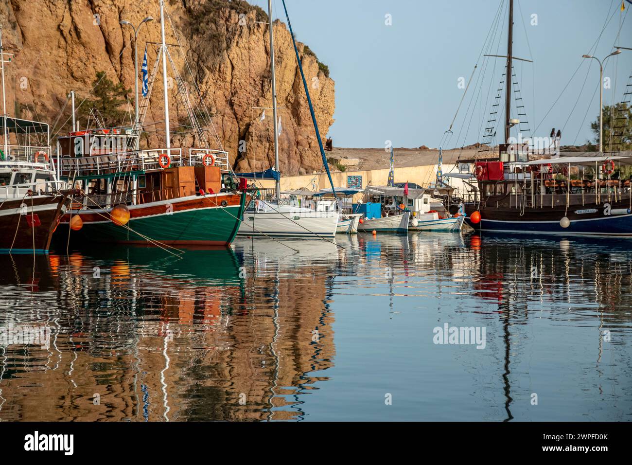 Small boats and yachts docked on the marina park with oceanfront view ...