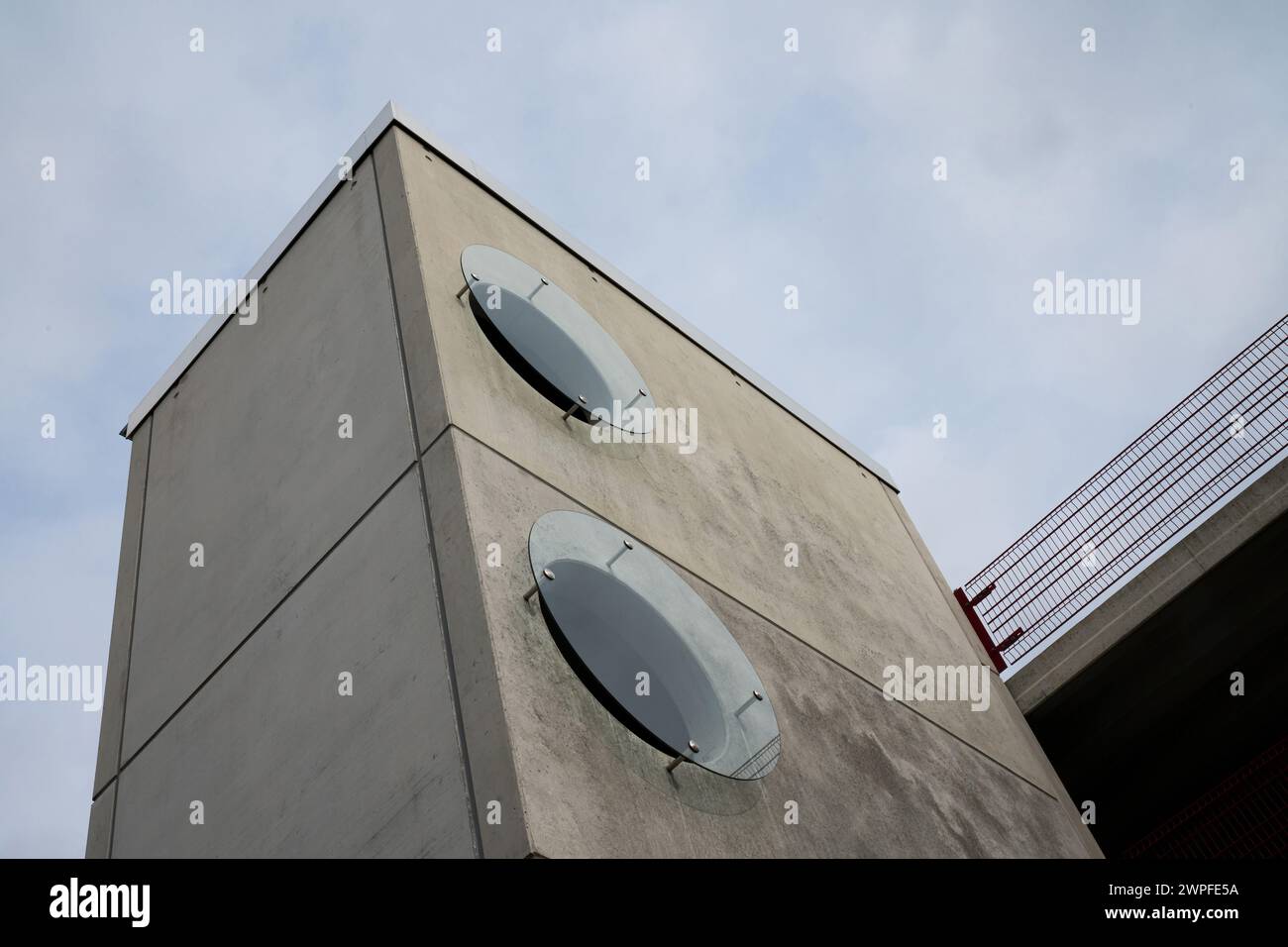 The walls of a concrete rectangular building with round windows. Bottom ...