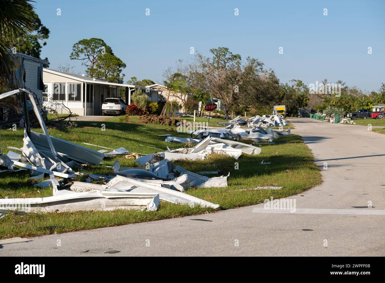 Scrap metal disposed in heaps on street side after hurricane severely ...