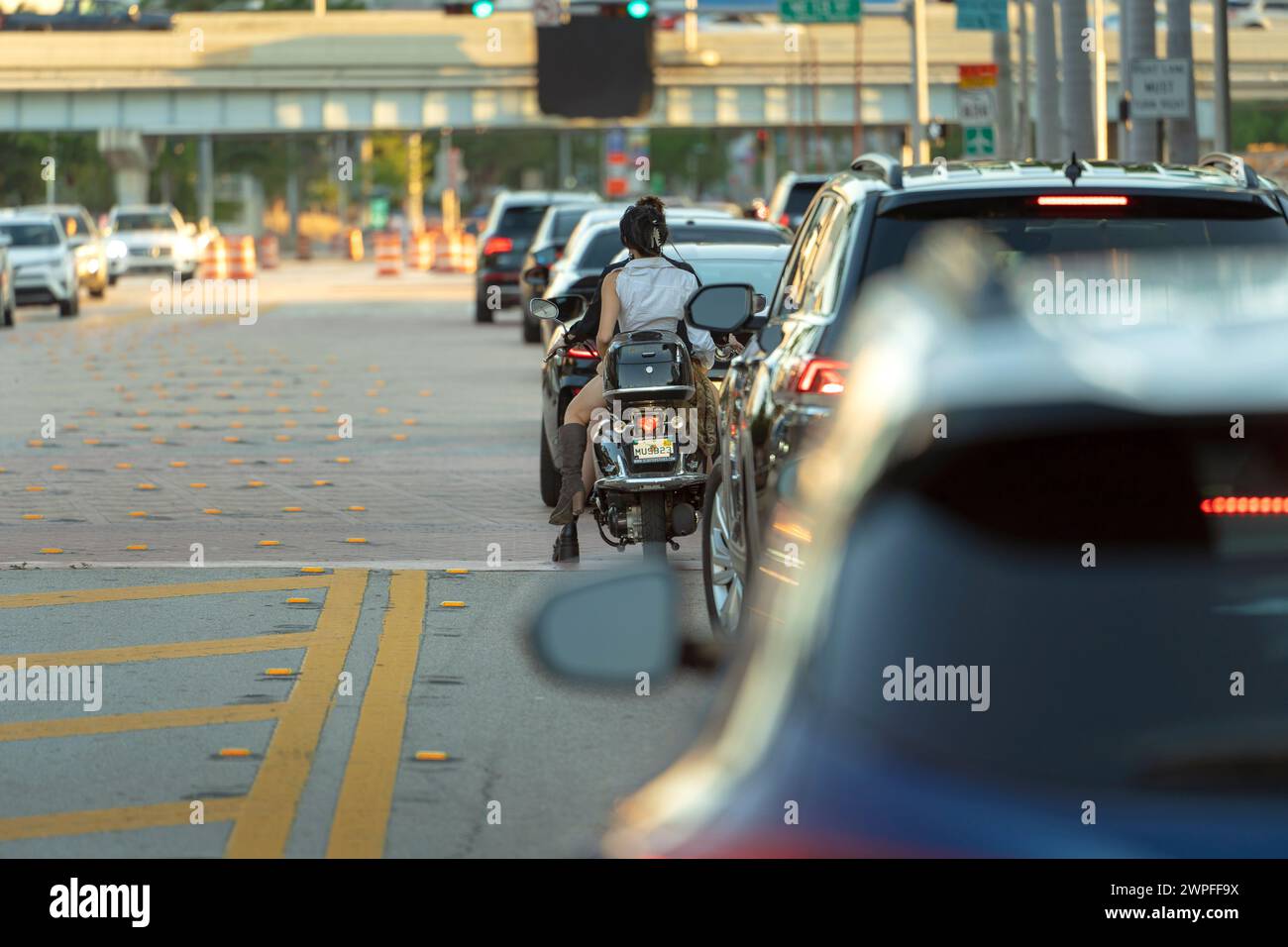 Traffic lights regulating driving motorcycle and cars on city street in ...