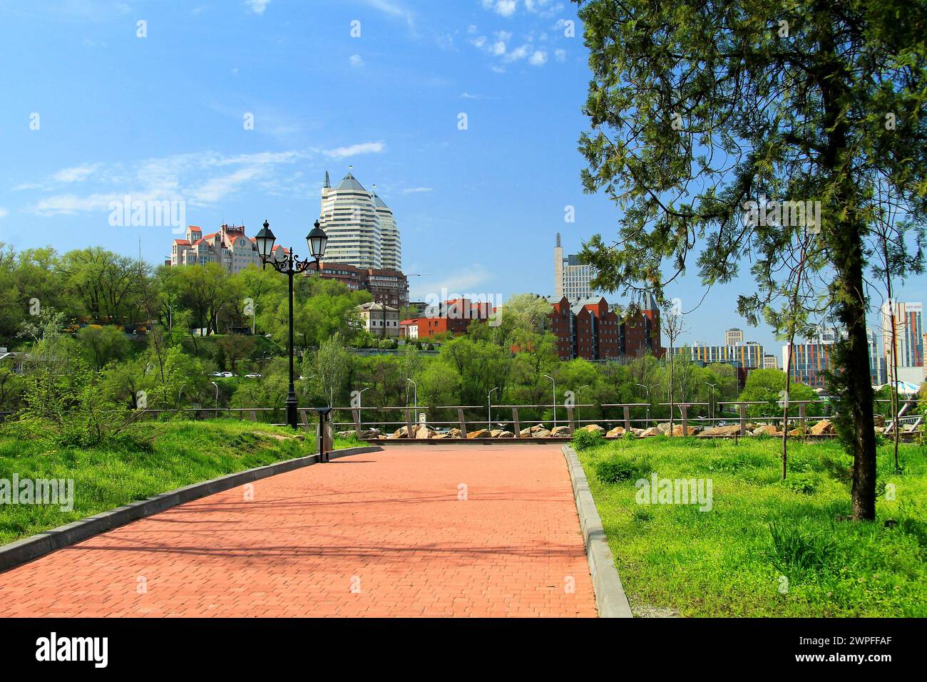 Beautiful tall towers, skyscrapers, red buildings, park against sky in ...