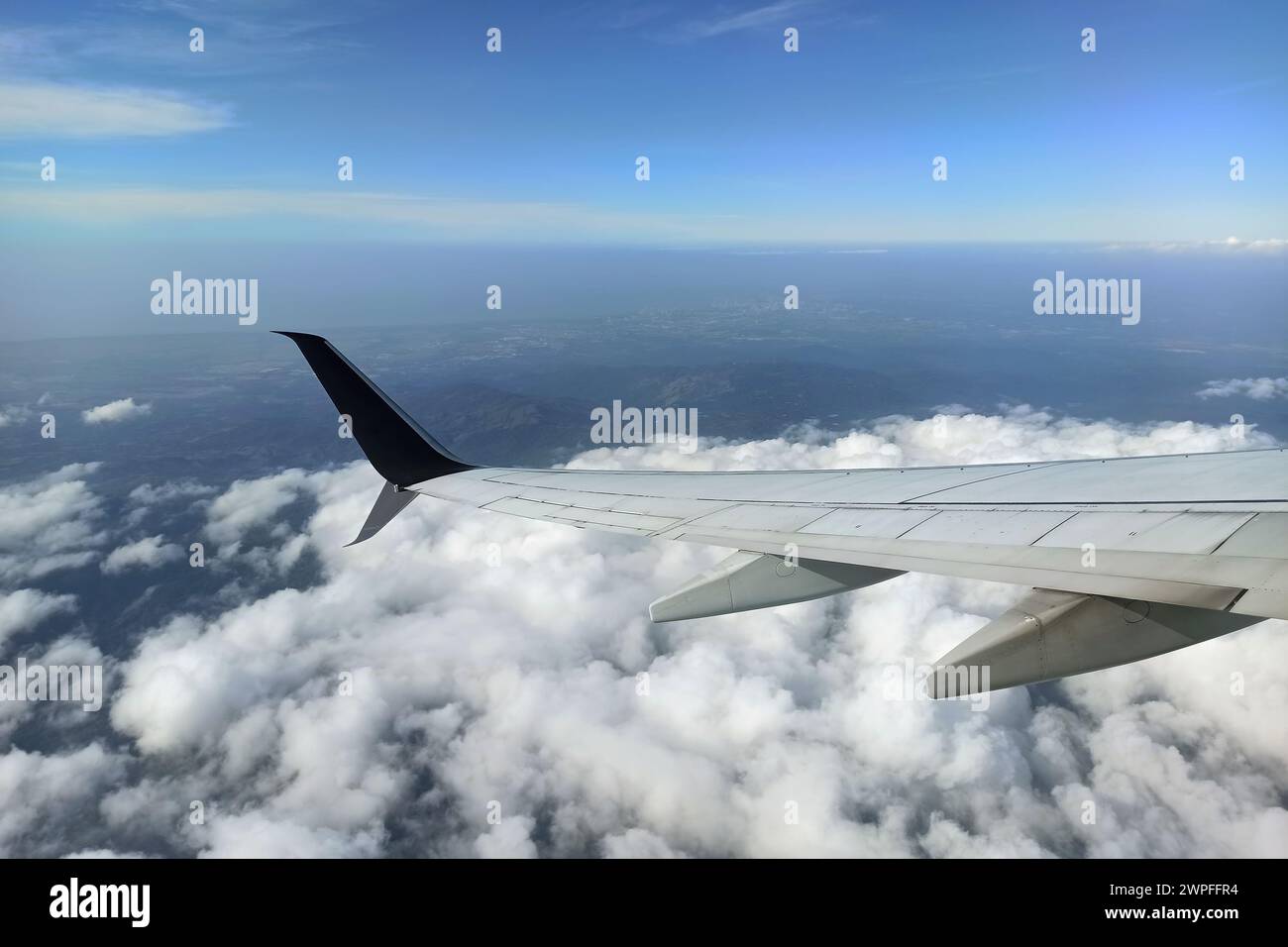 View through airplane window of commercial jet plane wing flying high ...