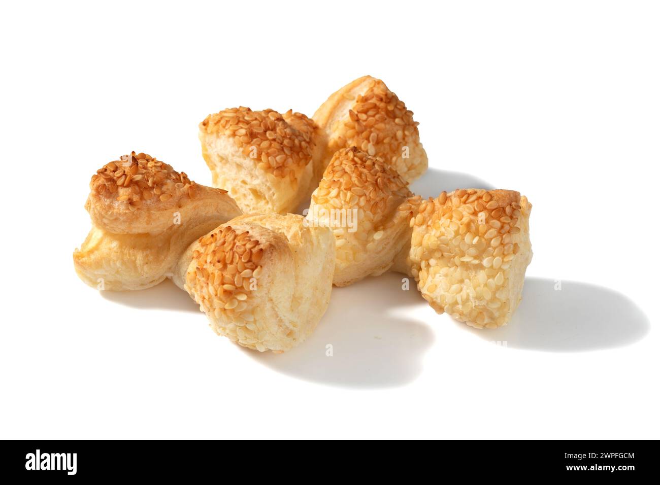 Three golden crackers boast a delightful twist and sprinkle of sesame ...
